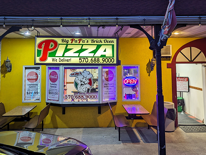The neon glow of Big PaPa's at night isn't just a beacon for hungry travelers—it's a promise of brick oven perfection waiting inside.