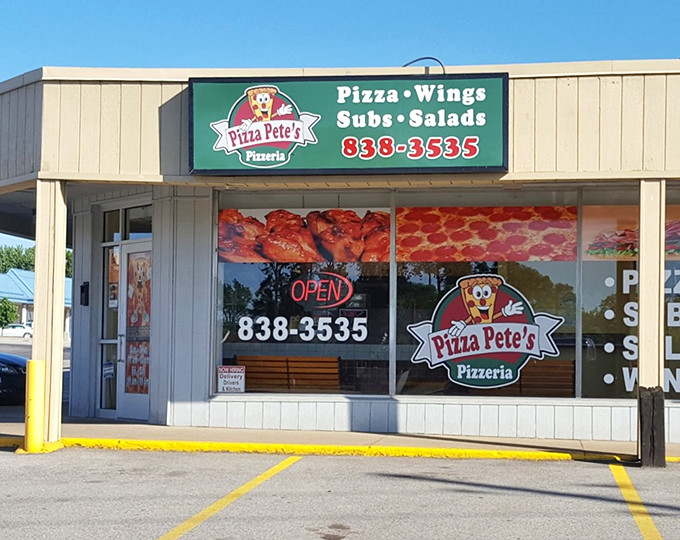 The green and white beacon of Pizza Pete's stands proud in Erie, where locals know that behind that cheerful cartoon mascot lies some seriously good pizza.
