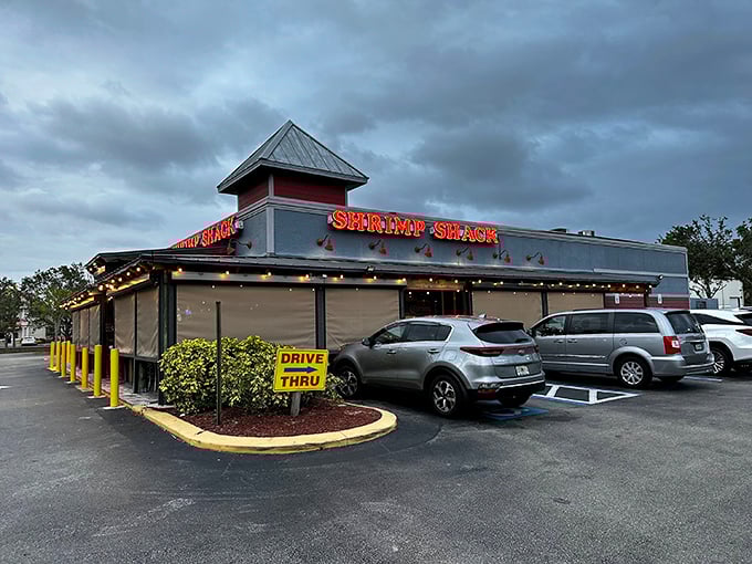 The unassuming exterior of Shrimp Shack belies the seafood treasures within. That bright red sign is like a lighthouse for hungry souls.