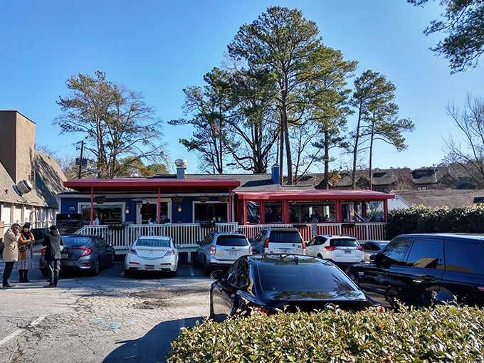 The little blue house with the bright red porch that's causing traffic jams in Buckhead isn't selling real estate—it's serving breakfast worth setting your alarm for.