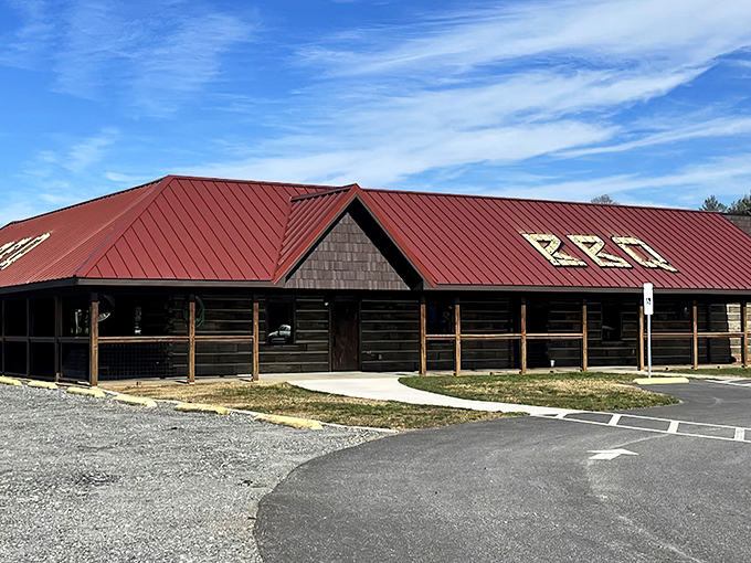 The rustic log cabin exterior with its signature red roof isn't trying to impress anyone—until you taste what's happening inside.