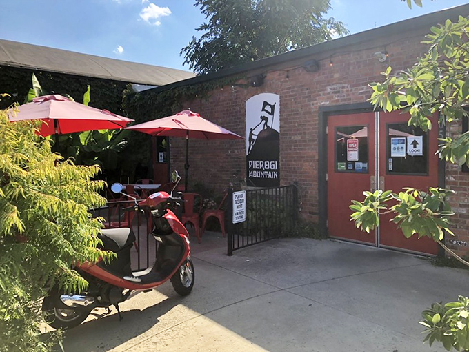 The unassuming brick exterior of Pierogi Mountain beckons with its vibrant red umbrellas and casual charm—proof that culinary treasures often hide in plain sight.