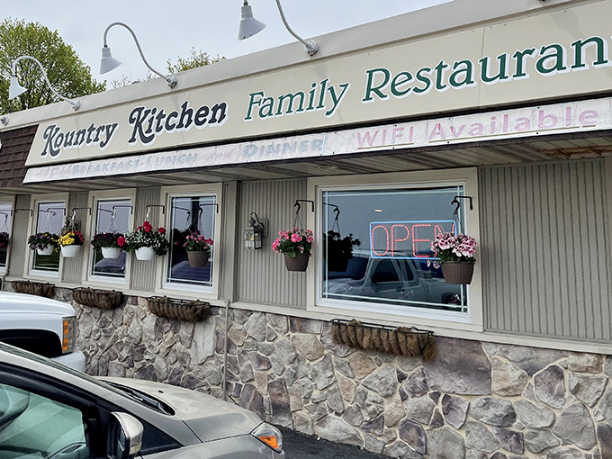 The stone foundation and hanging flower baskets aren't just country charm – they're a promise that comfort food awaits inside this Pennsylvania treasure.
