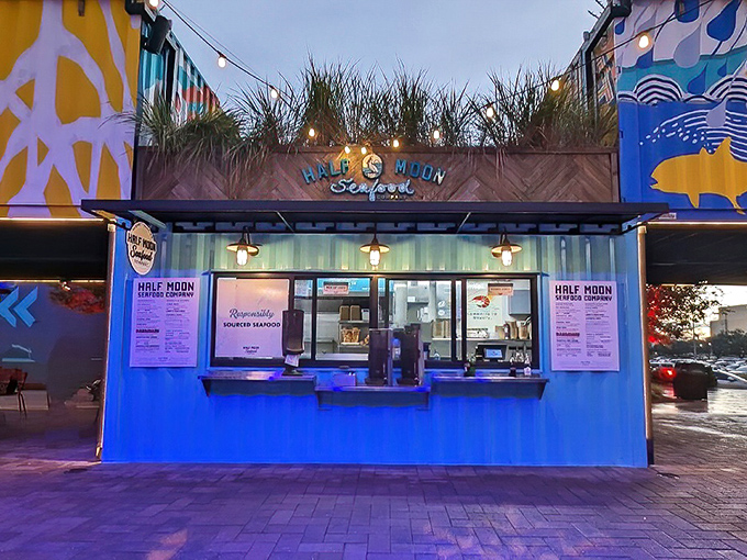 The turquoise shipping container exterior of Half Moon Seafood Co. isn't just eye-catching—it's a beacon for seafood lovers hiding in plain sight.