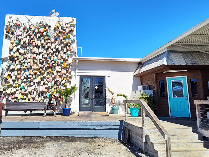 The wall of colorful buoys isn't just decoration—it's a maritime résumé telling stories of waters navigated and catches landed.
