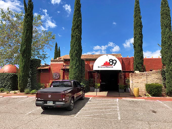 The terracotta fortress of flavor stands guard with cypress sentinels, promising carnivorous delights within Sedona's rustic-chic dining scene.