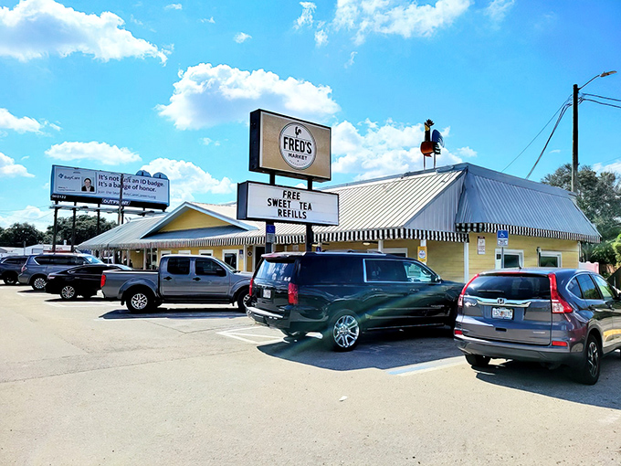 Fred's sunny yellow exterior promises comfort before you even walk in. That "FREE SWEET TEA REFILLS" sign isn't just advertising—it's a love letter to the South.