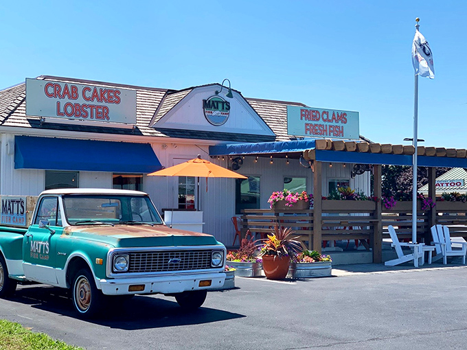 The coastal charm hits you before the first bite—white clapboard, blue awnings, and those inviting Adirondack chairs practically whispering "seafood paradise ahead."