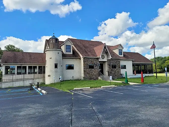 The lighthouse-inspired exterior of Kathy's Crab House stands as a beacon to seafood lovers, promising maritime treasures within those stone-faced walls.