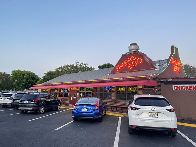 That iconic red roof and neon signage isn't just eye-catching—it's a smoke signal to BBQ lovers that paradise awaits inside.