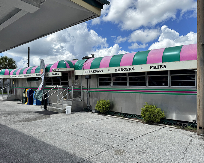 That iconic pink and green awning isn't just eye-catching—it's a beacon of burger perfection that's been drawing hungry Floridians to Palatka since 1932.