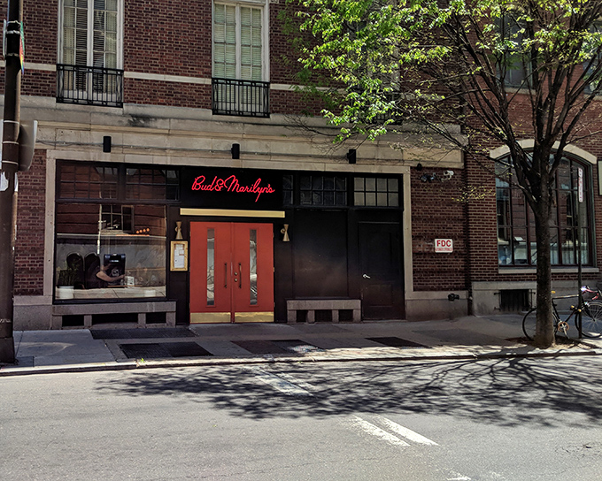 Those bright orange doors aren't just an entrance—they're a promise of the comfort food paradise waiting inside. Philadelphia's culinary scene at its most inviting.