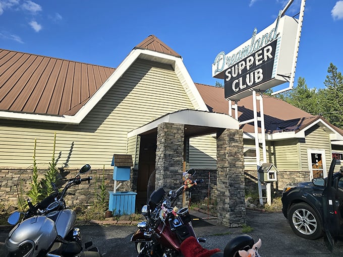 The classic supper club exterior beckons with its vintage sign and stone columns—motorcycles out front always a good sign that locals know something you don't.