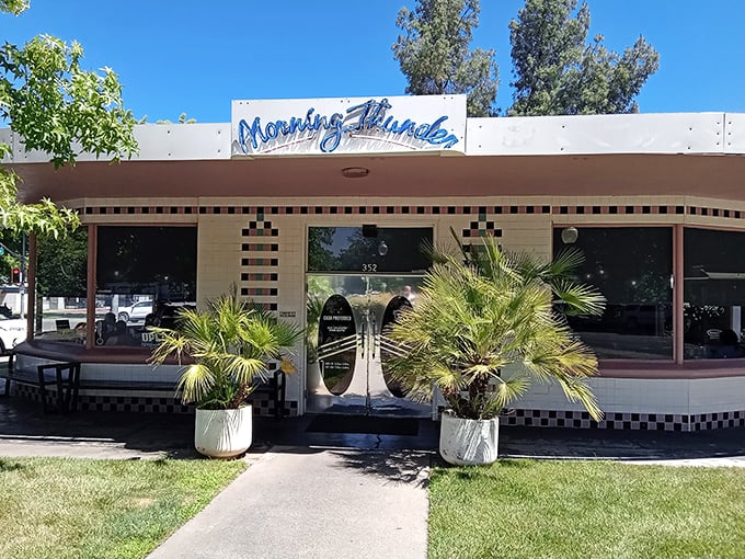The iconic blue Morning Thunder sign welcomes hungry patrons, who patiently wait outside like pilgrims at a breakfast temple.