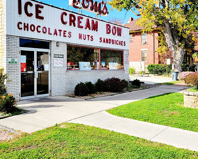The classic white brick façade of Tom's Ice Cream Bowl stands as a time capsule of Americana, promising sweet memories and even sweeter treats inside.