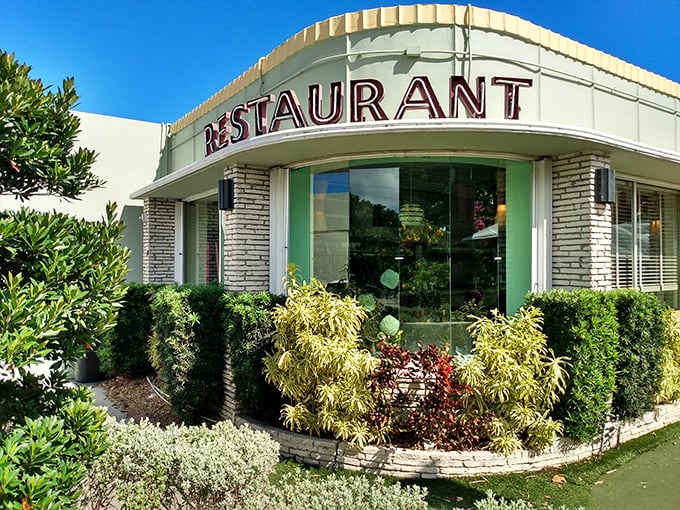 The mint-green time machine of Howley's beckons with its classic "RESTAURANT" sign—a mid-century promise of comfort that never goes out of style.