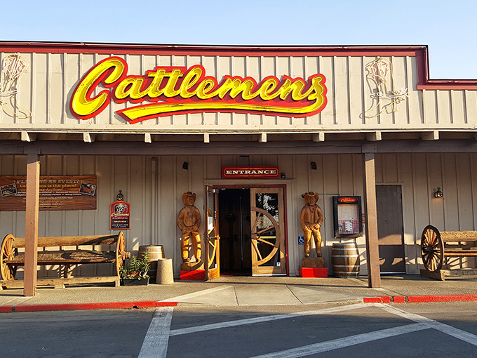 The iconic yellow Cattlemens sign welcomes hungry travelers like a beacon of beef-related bliss. Those wooden cowboys aren't just decorative—they're promising you the steak of your dreams.