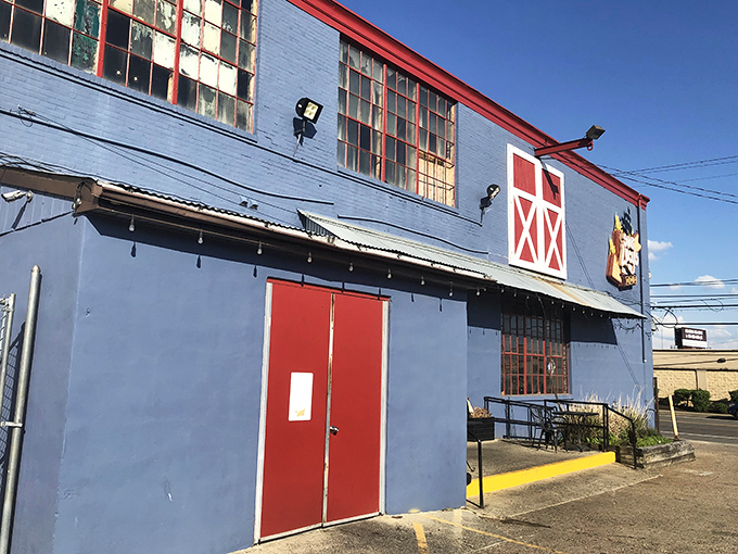 The blue exterior with red barn-style accents isn't just eye-catching—it's a smoke signal to BBQ lovers that something special awaits inside.
