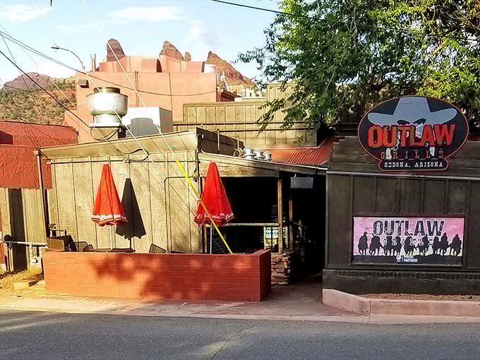The Outlaw Grille's weathered wooden exterior isn't trying to impress anyone—it's too busy preparing to blow your taste buds away with honest-to-goodness flavor.