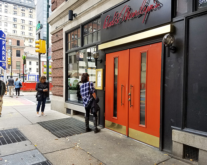 Those bright orange doors aren't just an entrance—they're a promise of the comfort food paradise waiting inside. Philadelphia's culinary scene at its most inviting.