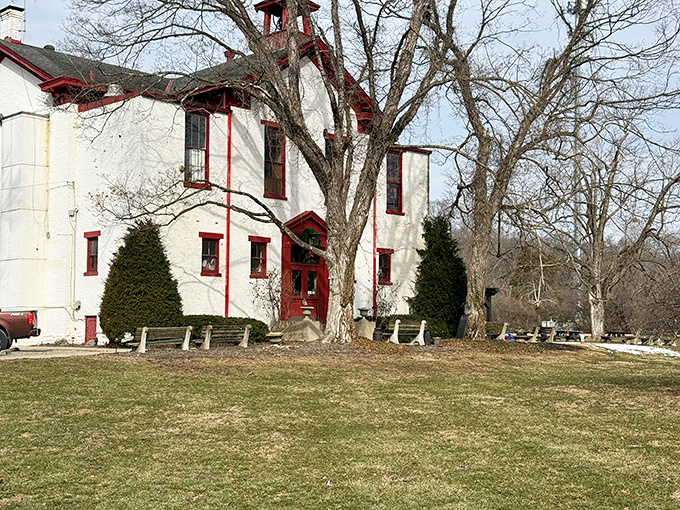 That iconic red bell tower isn't just for show – it signals serious comfort food awaits inside this charming converted schoolhouse.