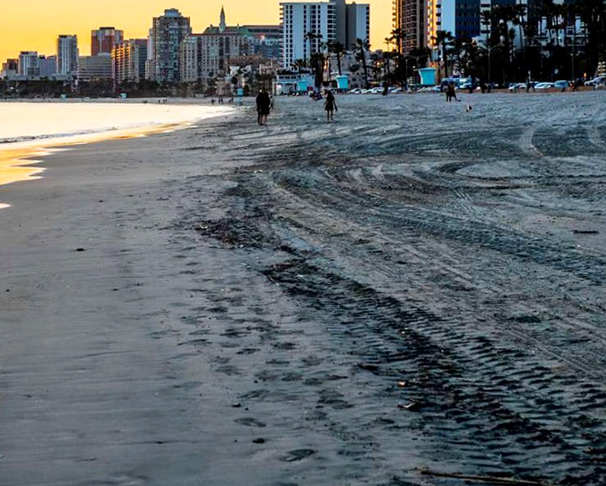 Golden hour transforms Long Beach's shoreline into a postcard-perfect scene, where turquoise lifeguard towers stand sentinel over rippling sands.