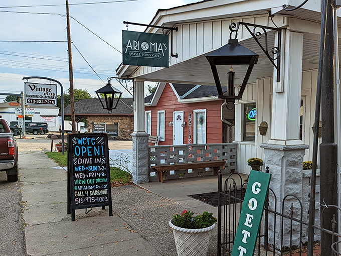 The charming exterior of Ari & Mia's beckons with its vintage lanterns and welcoming "GOETTA" sign—a true Ohio small-town treasure.