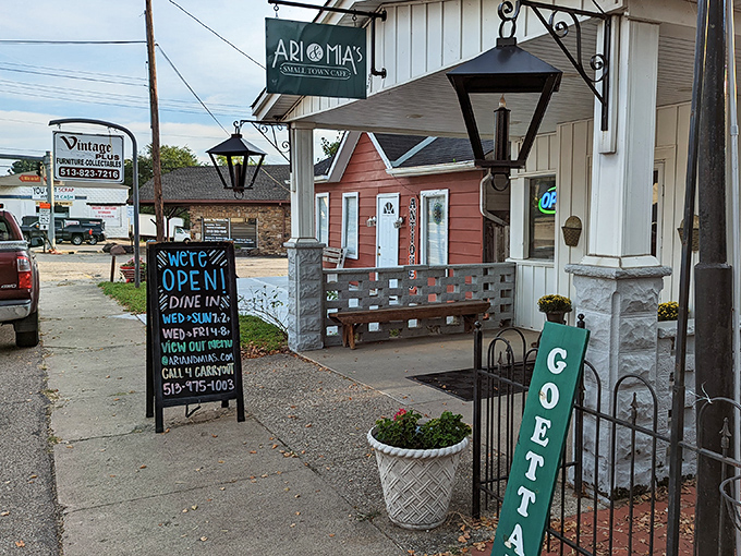 The charming exterior of Ari & Mia's beckons with its vintage lanterns and welcoming "GOETTA" sign—a true Ohio small-town treasure.