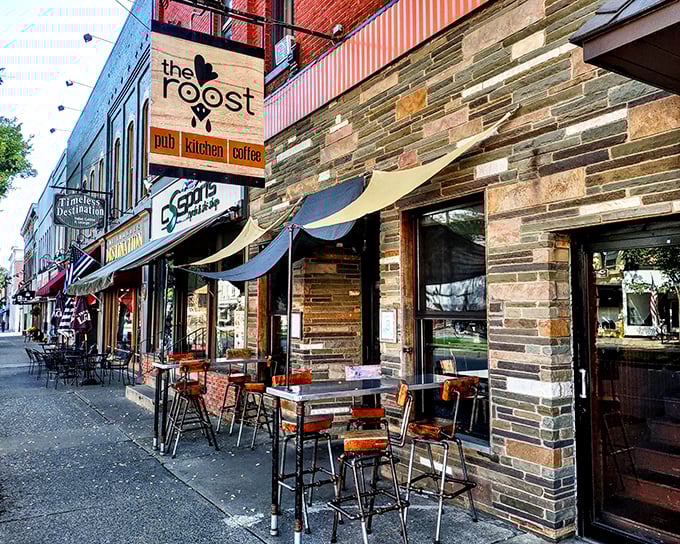 The charming stone facade of The Roost beckons from Wellsboro's picturesque Main Street, where barrel tables invite passersby to linger over craft brews and conversation.