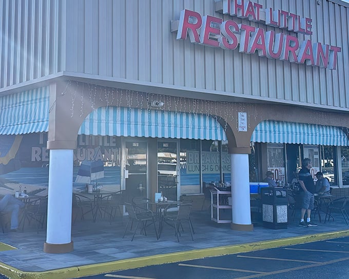 The bright red sign beckons like a lighthouse for hungry souls. That Little Restaurant's unassuming strip mall exterior hides culinary treasures within.