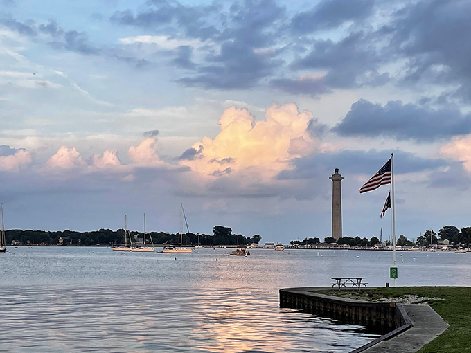 Sunset magic at Oak Point State Park, where Lake Erie's waters meet a sky painted in pastels and Perry's Monument stands sentinel over island memories.