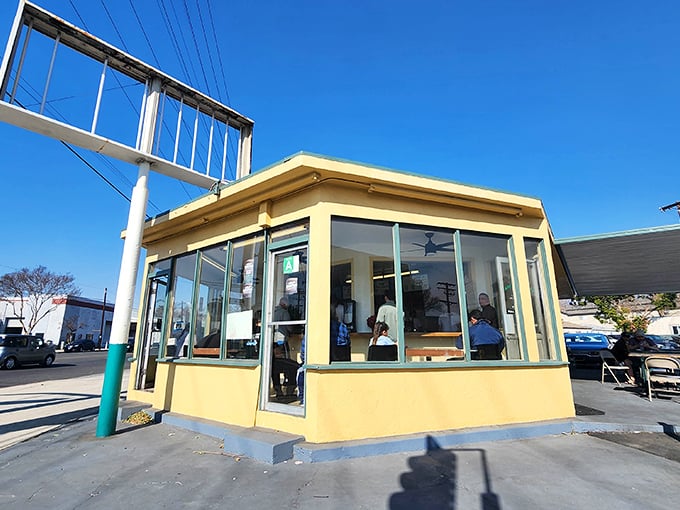 This cheerful yellow cottage looks like it wandered off a postcard and decided to serve breakfast burritos instead.