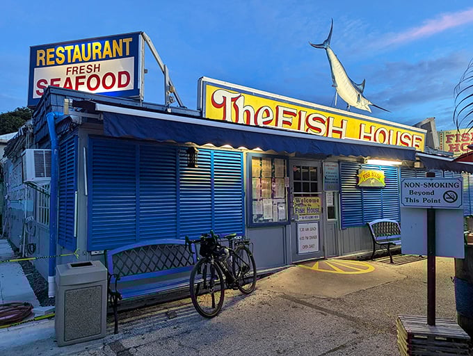 The blue exterior of The Fish House stands like a seafood beacon in Key Largo, complete with a marlin silhouette that practically screams "fresh catch inside!"