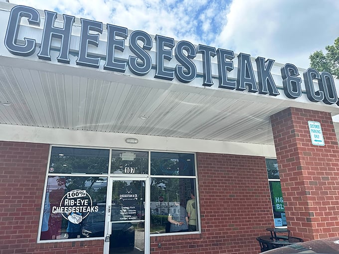 The sign says it all – Cheesesteak & Co. stands proud against the Maryland sky, promising meaty delights within its brick walls.