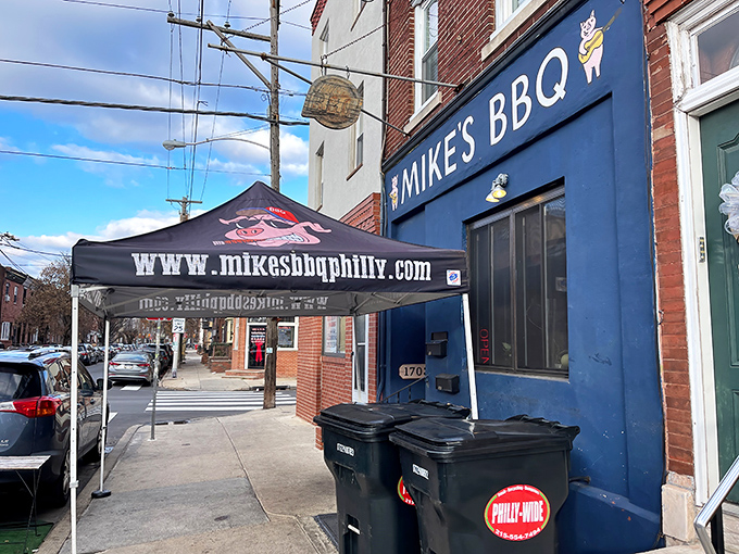 The bright blue storefront of Mike's BBQ stands out on East Passyunk Avenue like a beacon for meat lovers. The sidewalk tent hints at the smoky treasures waiting inside.