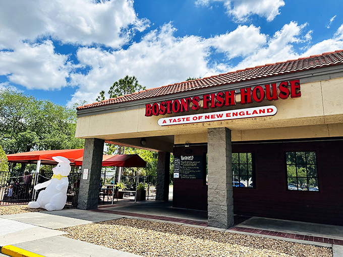 The iconic red lettering of Boston's Fish House beckons seafood lovers, while that inflatable polar bear stands guard in the Florida heat—a delightfully puzzling sentinel.