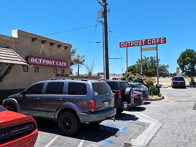 The iconic red sign beckons like an old friend against the desert sky—a promise of comfort food that's kept travelers returning for generations.