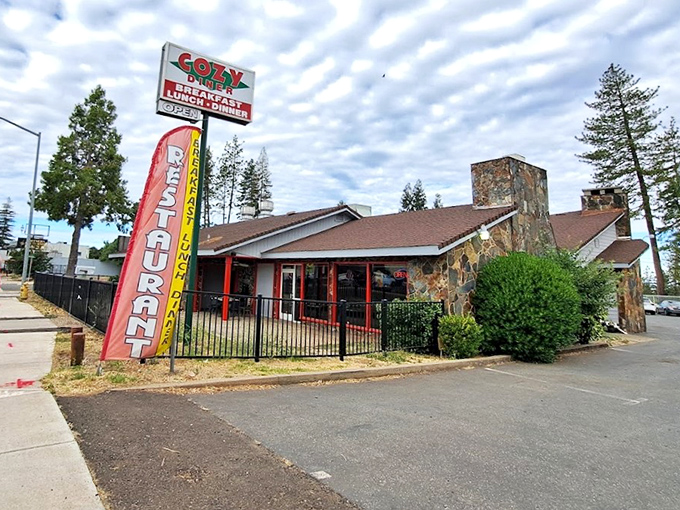 The stone facade and classic neon sign promise what every road trip deserves—a genuine diner experience where comfort trumps pretension.