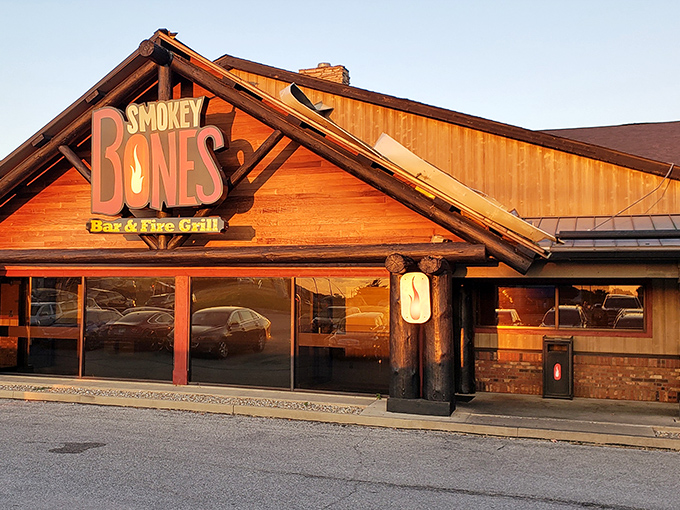 The rustic log cabin exterior beckons like a barbecue mirage in the prairie landscape. This isn't just a restaurant—it's a smoke signal to hungry travelers.
