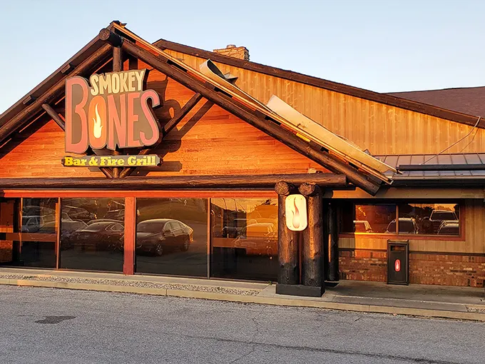 The rustic log cabin exterior beckons like a barbecue mirage in the prairie landscape. This isn't just a restaurant—it's a smoke signal to hungry travelers.