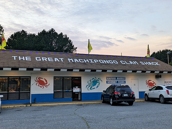 The unassuming exterior of The Great Machipongo Clam Shack stands like a seafood lighthouse, beckoning hungry travelers with its colorful crab murals and no-nonsense charm.