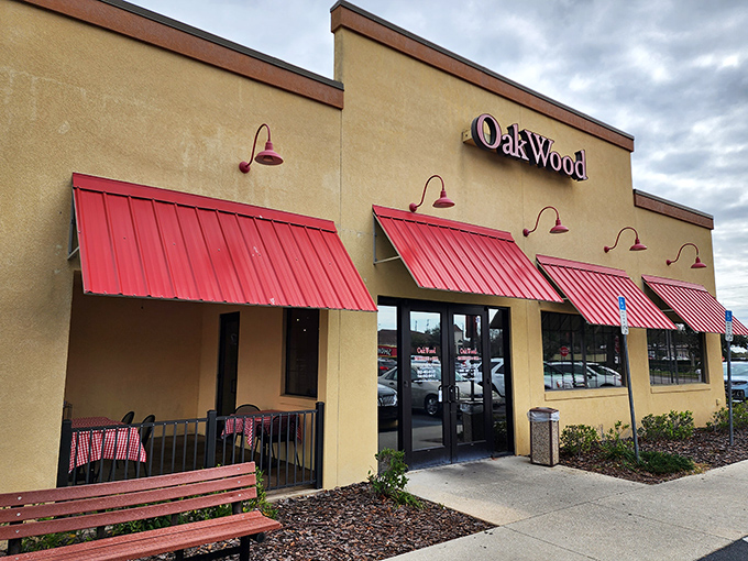 The welcoming tan exterior with bright red awnings promises what every BBQ pilgrim seeks – authentic flavor without pretension.