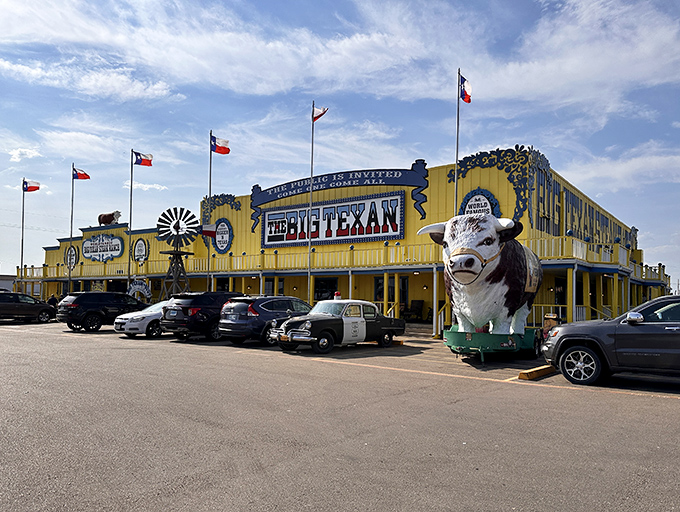 The yellow facade of The Big Texan shines like a beacon of beef-related hope on the Texas horizon. Those flags aren't just for show—they're summoning you to steak paradise. 