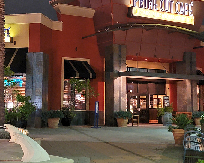 The terra cotta façade glows like a beacon for hungry souls, promising meaty salvation within those stylish doors.
