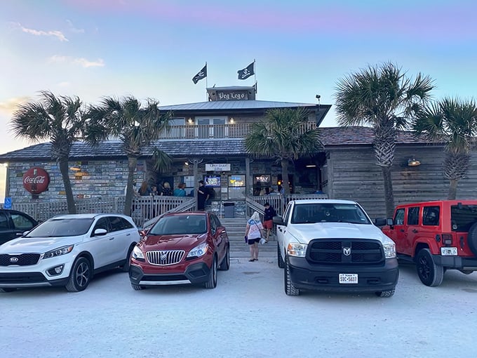 Pirate flags flying high above weathered wood planks—this isn't just a restaurant entrance, it's the gateway to seafood paradise.