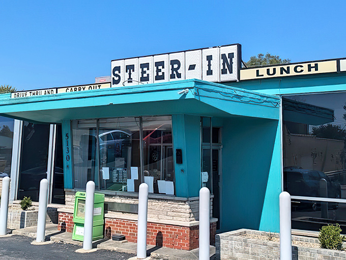 The turquoise time machine beckons! Steer-In's vintage exterior promises comfort food treasures that have sustained Indianapolis locals for generations.
