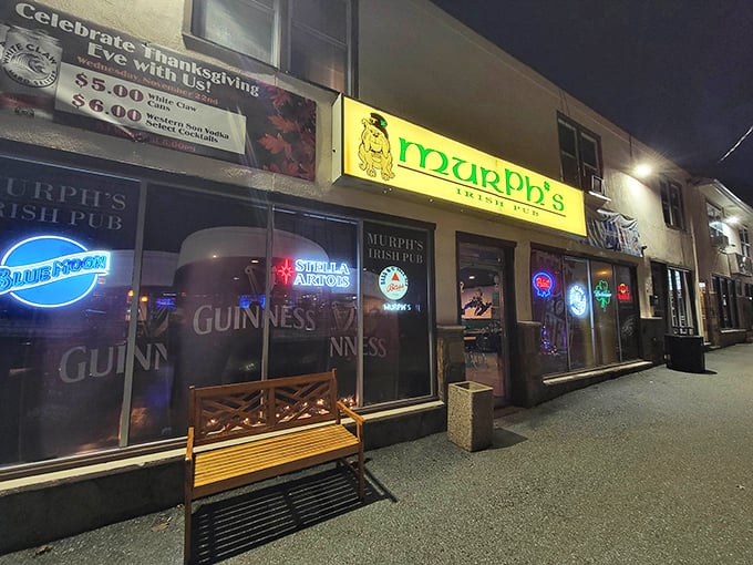 The glowing green sign of Murph's Irish Pub cuts through the night like a beacon for thirsty souls. A wooden bench awaits those needing a breather between pints.