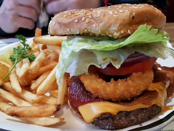 This isn't just a burger, it's architectural genius—stacked high with an onion ring, bacon, and cheese that melts into every delicious crevice.