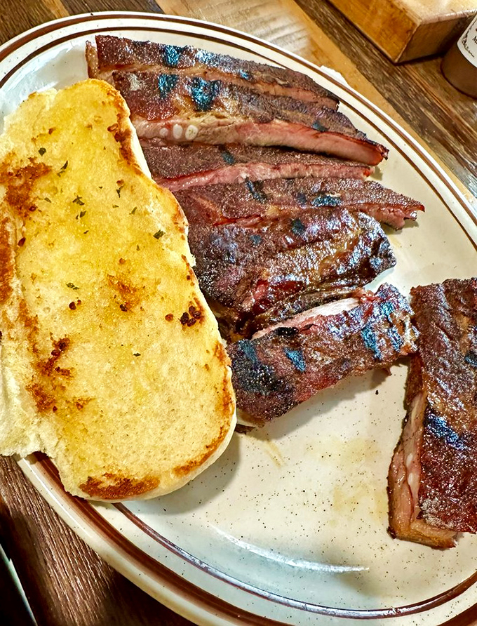 These ribs aren't just cooked—they're seduced by smoke and fire until they achieve BBQ nirvana on your plate.