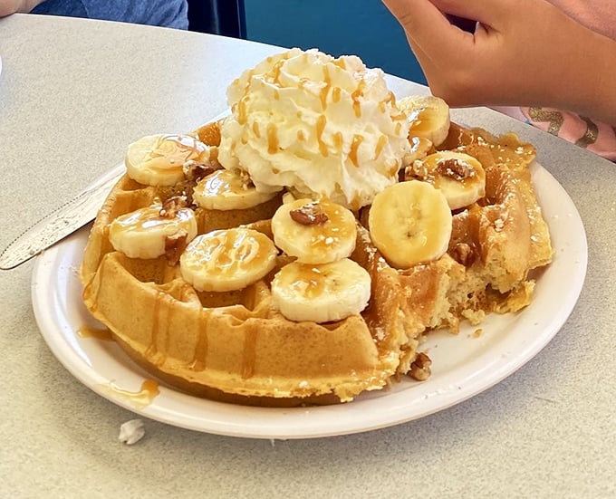 This banana-topped waffle with whipped cream isn't just breakfast—it's dessert with an alibi, and sometimes that's exactly what the morning requires.